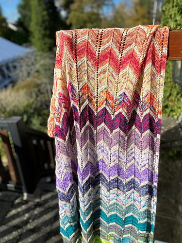 Ravelry: Chevron Twist Advent Wrap and Throw pattern by Fiona Wardingley