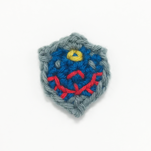 Ravelry: Link's Hyrule Shield Pin pattern by LouiesLoops