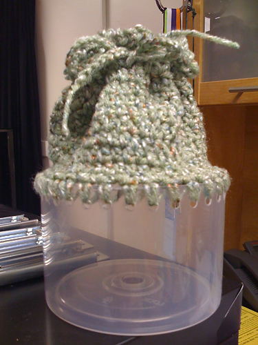 Ravelry: Yarn Ball Cozy from a CD Canister pattern by Jennifer Ofenstein